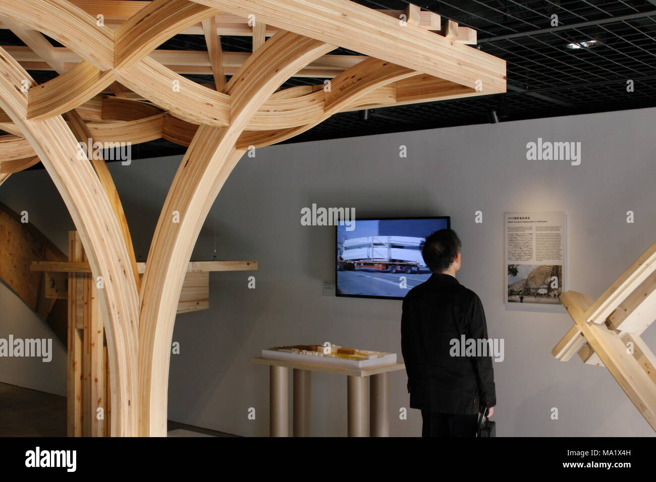 A visitor views an exhibit at the the 'Shigeru Ban: Projects in ...