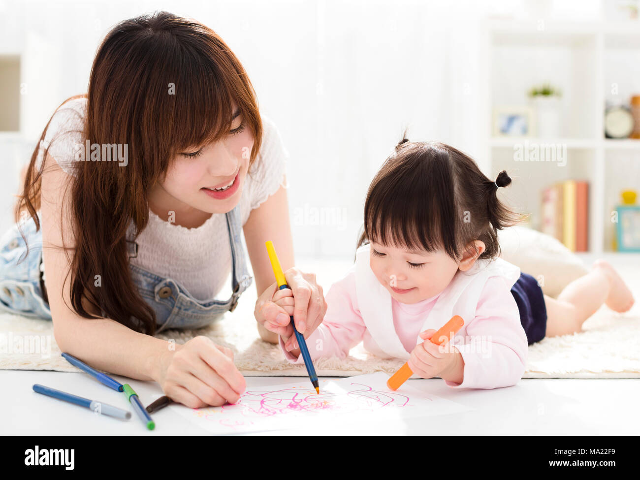 Mother teaching daughter paint hi-res stock photography and images - Alamy