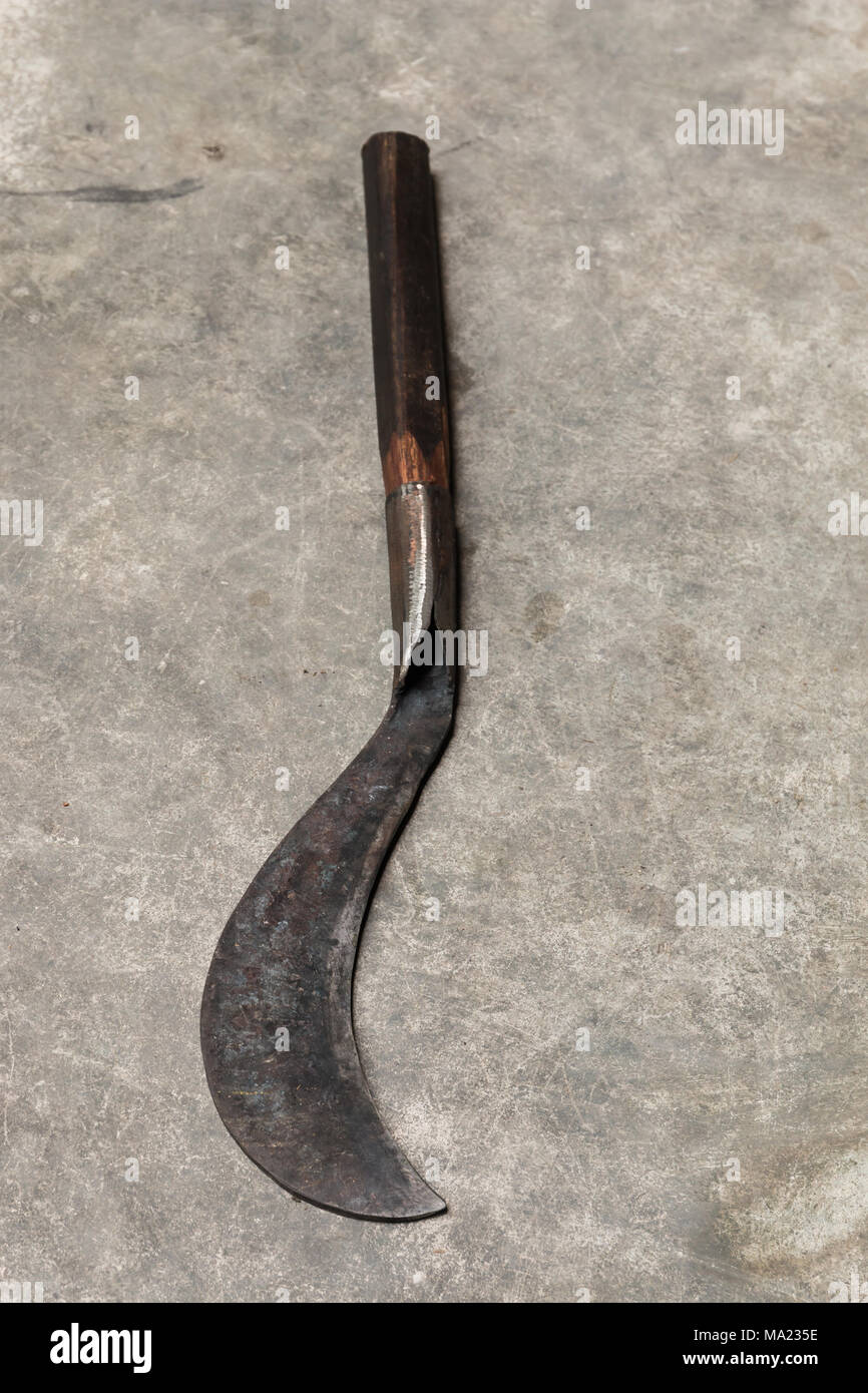 Thai style sickle knife on cement ground Stock Photo - Alamy