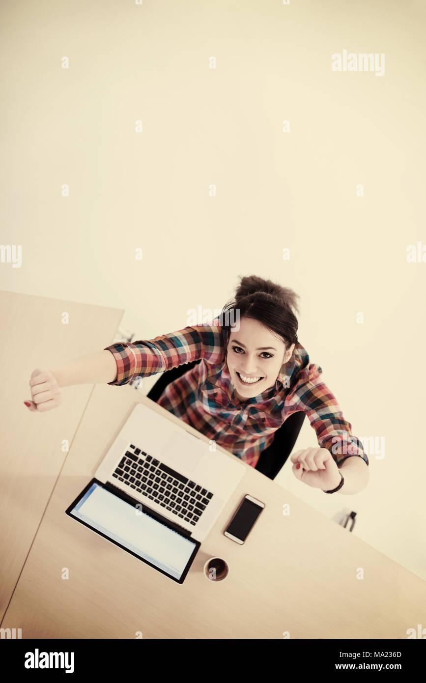 top view of young business woman working on laptop computer in modern ...