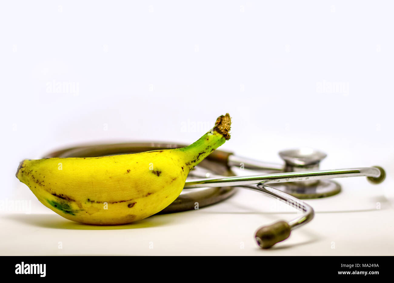 banana and stethoscope isolated in white background as doctor ...