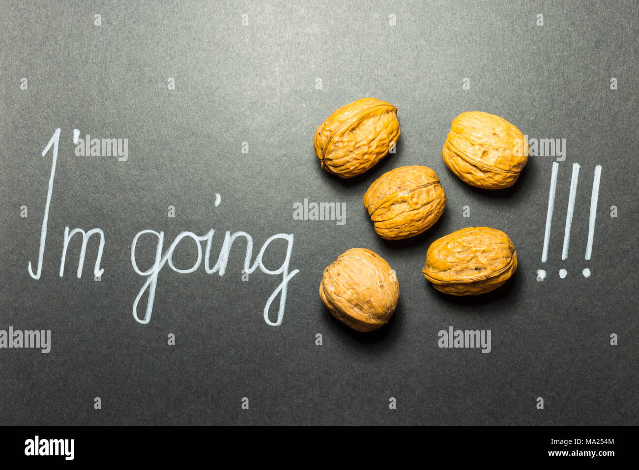 Concept of the phrase I'm going nuts with brown nuts and white hand ...