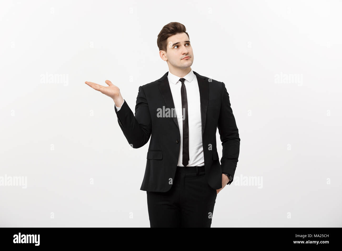 Business Concept: Attractive handsome business man shows hand on side ...