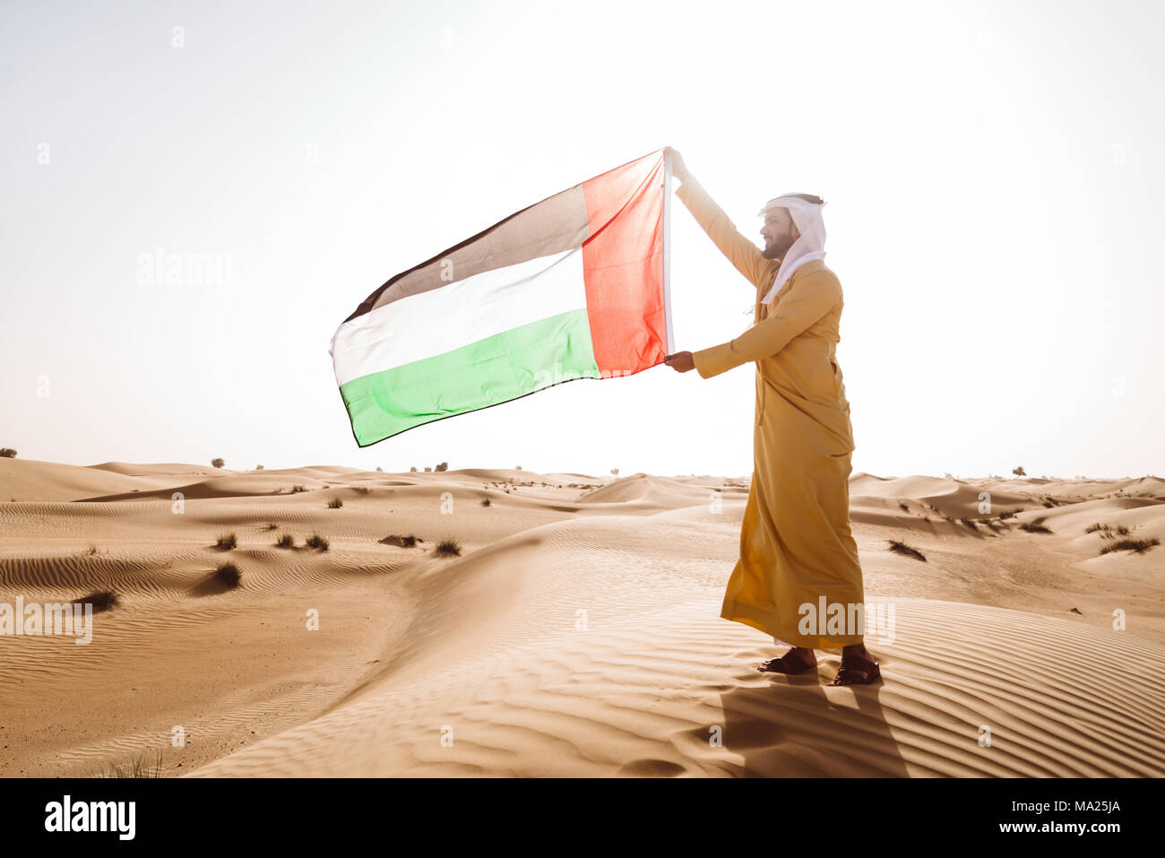 Man wearing traditional uae clothes spending time in the desert Stock ...