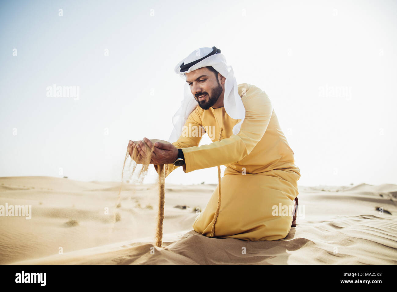 Man wearing traditional uae clothes spending time in the desert Stock ...