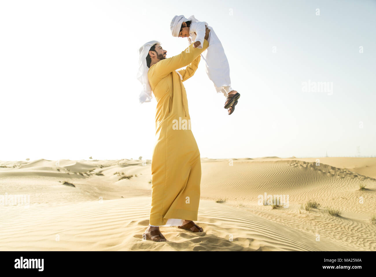 Father and son spending time in the desert Stock Photo - Alamy