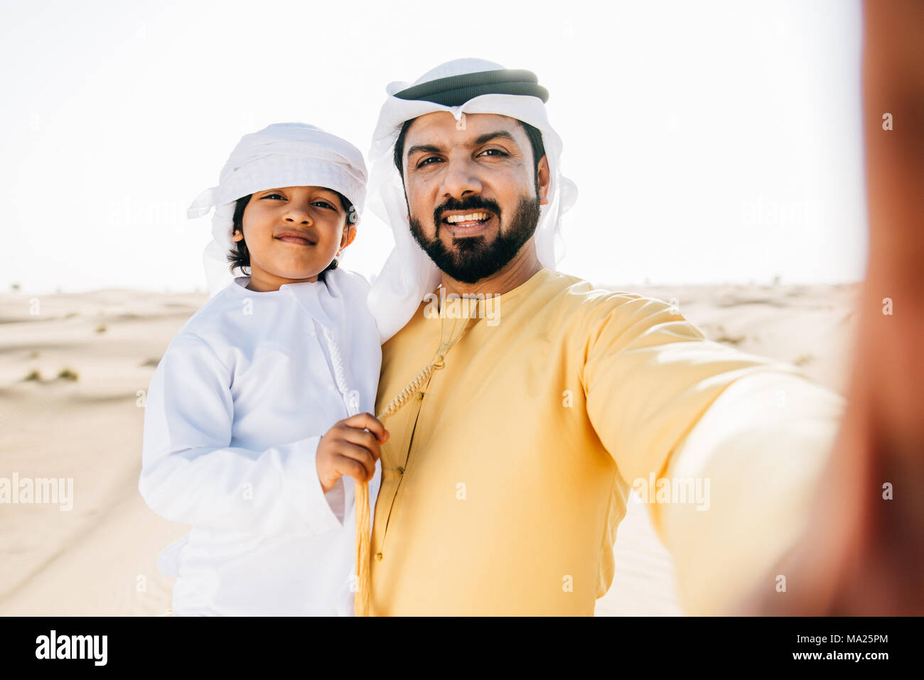 Father and son spending time in the desert Stock Photo - Alamy
