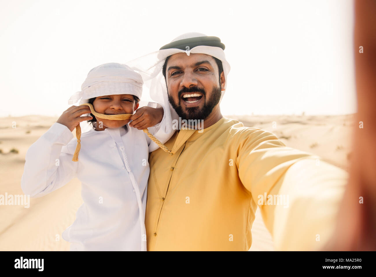 Father and son spending time in the desert Stock Photo - Alamy