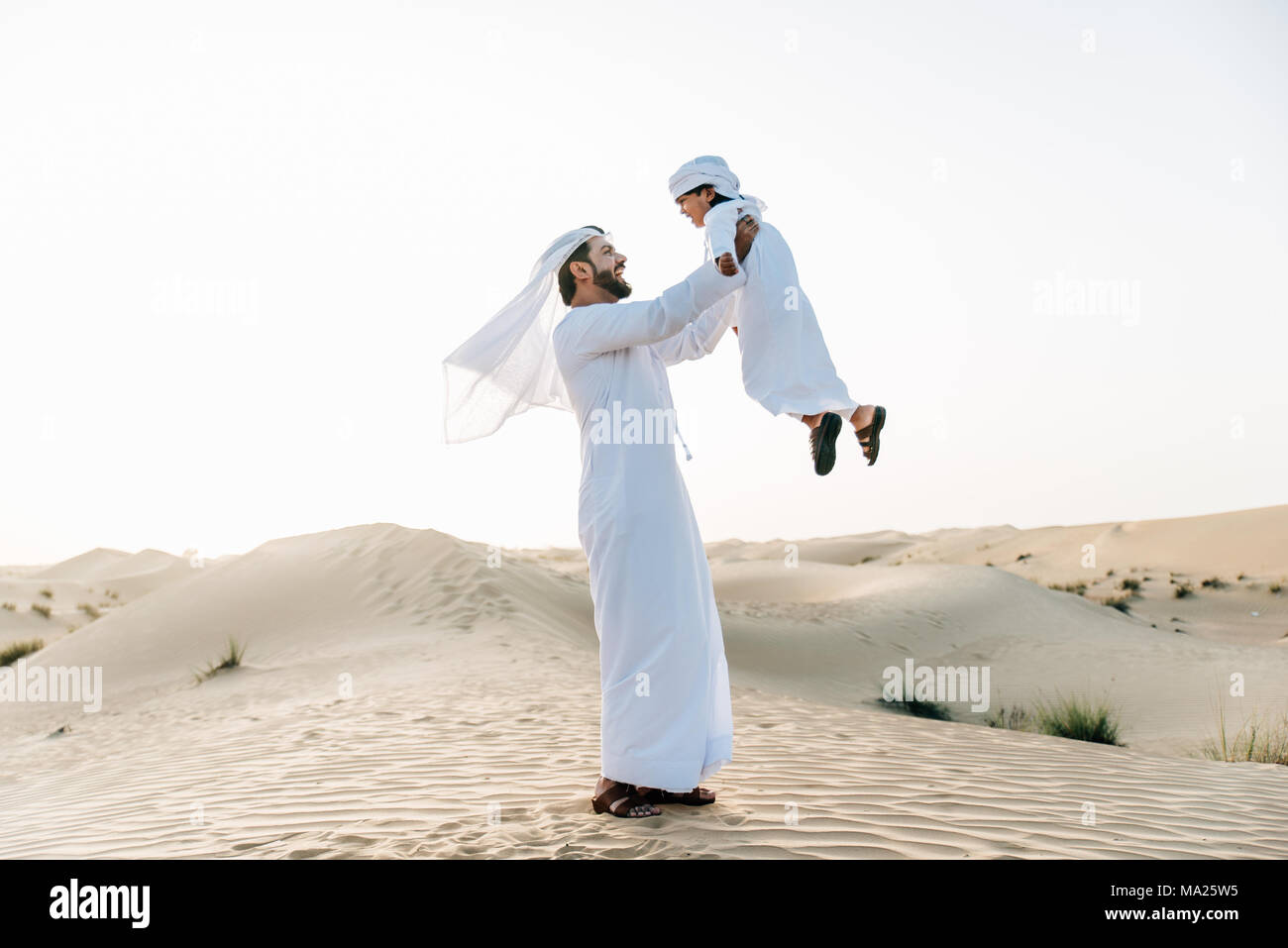 Father and son spending time in the desert Stock Photo - Alamy