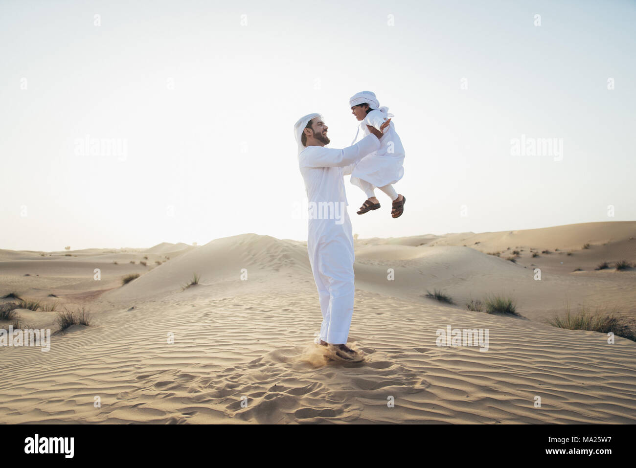 Father and son spending time in the desert Stock Photo - Alamy