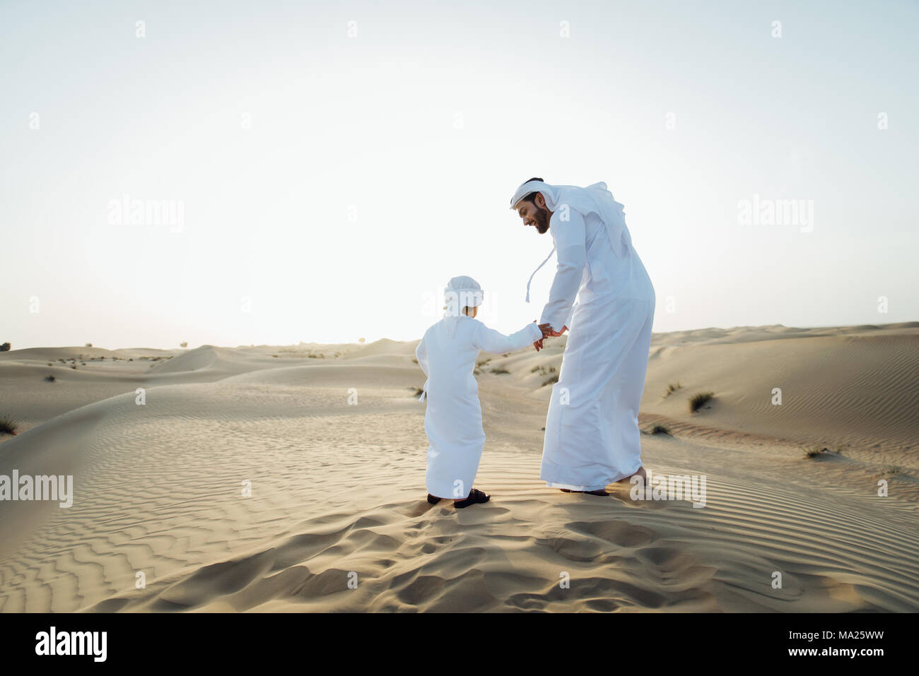 Father and son spending time in the desert Stock Photo - Alamy