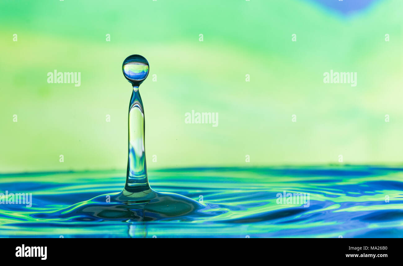 blue water droplets with a green background Stock Photo - Alamy
