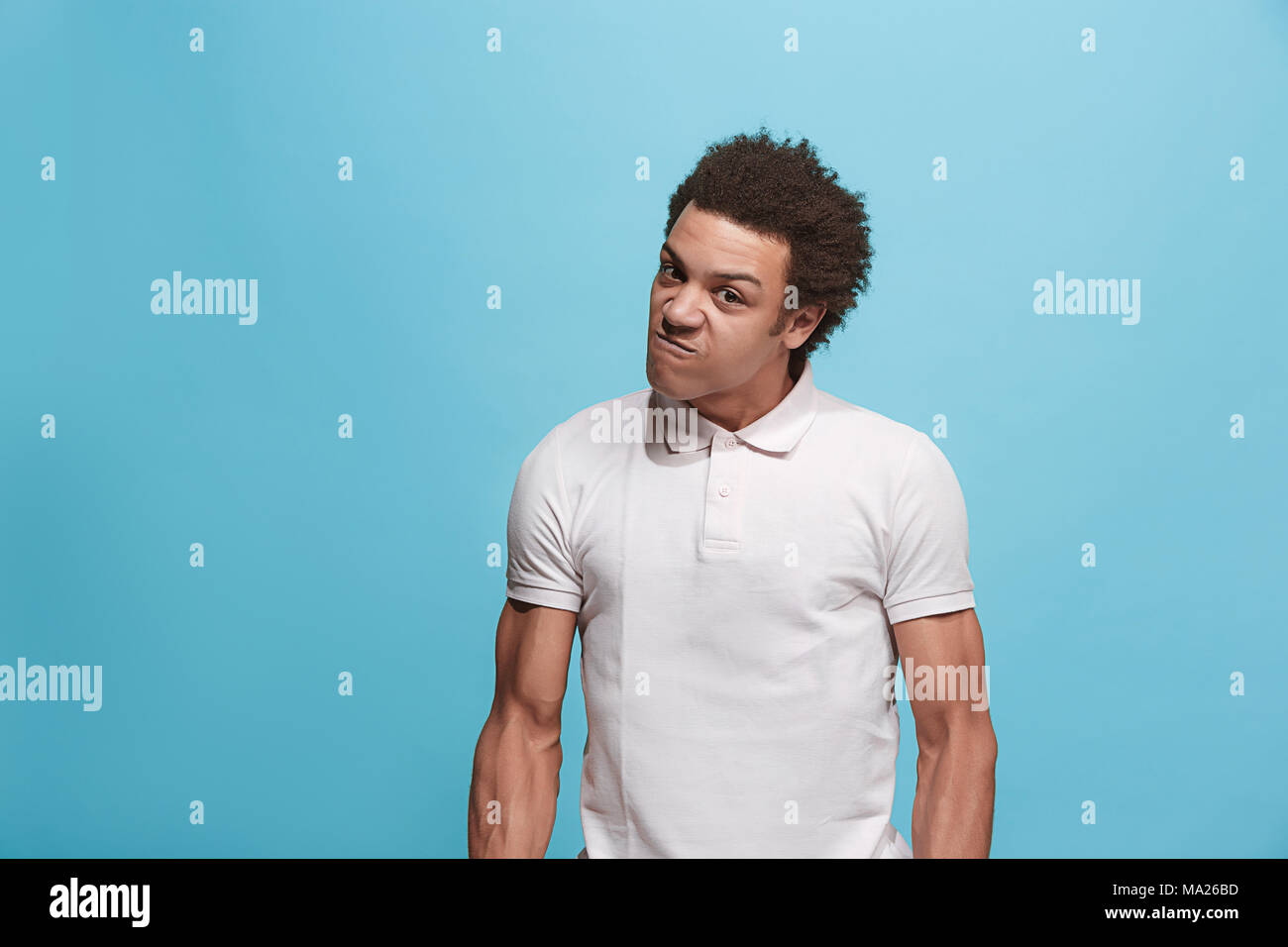 The young emotional angry man screaming on blue studio background Stock ...