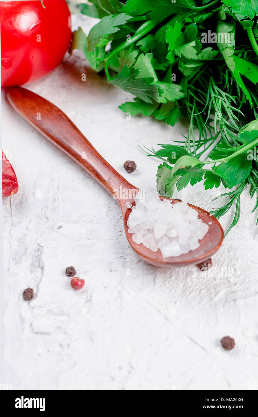 Ripe cherry tomato, green onion and parsley, garlic, solt in spoon and ...