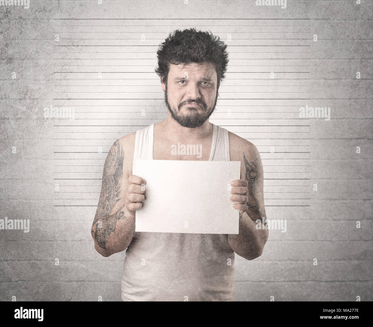 Gangster in front of a wall with table on his hand Stock Photo - Alamy