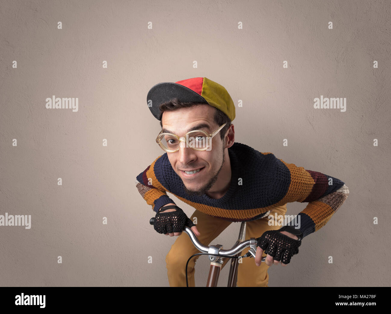 Nerd young foolish biker on a bike with oldschool outfit Stock Photo ...