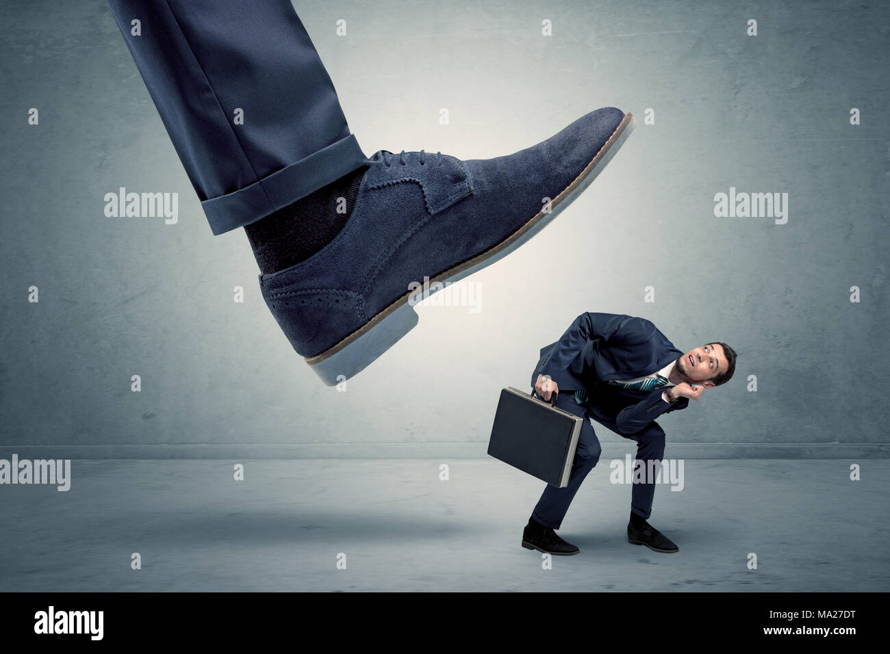 Demoralised employee symbolized by small man getting trampled Stock ...