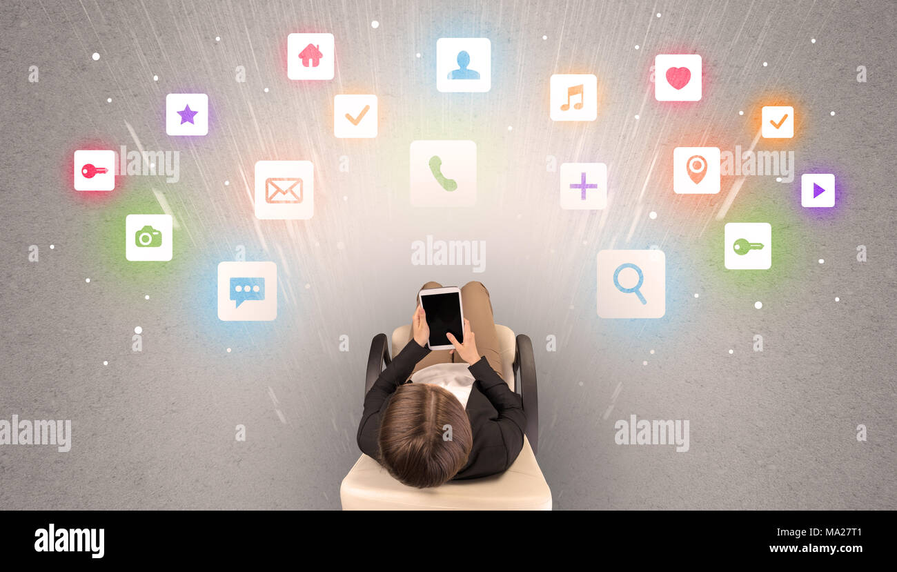 Application symbols with ith woman using device in a beige chair Stock ...