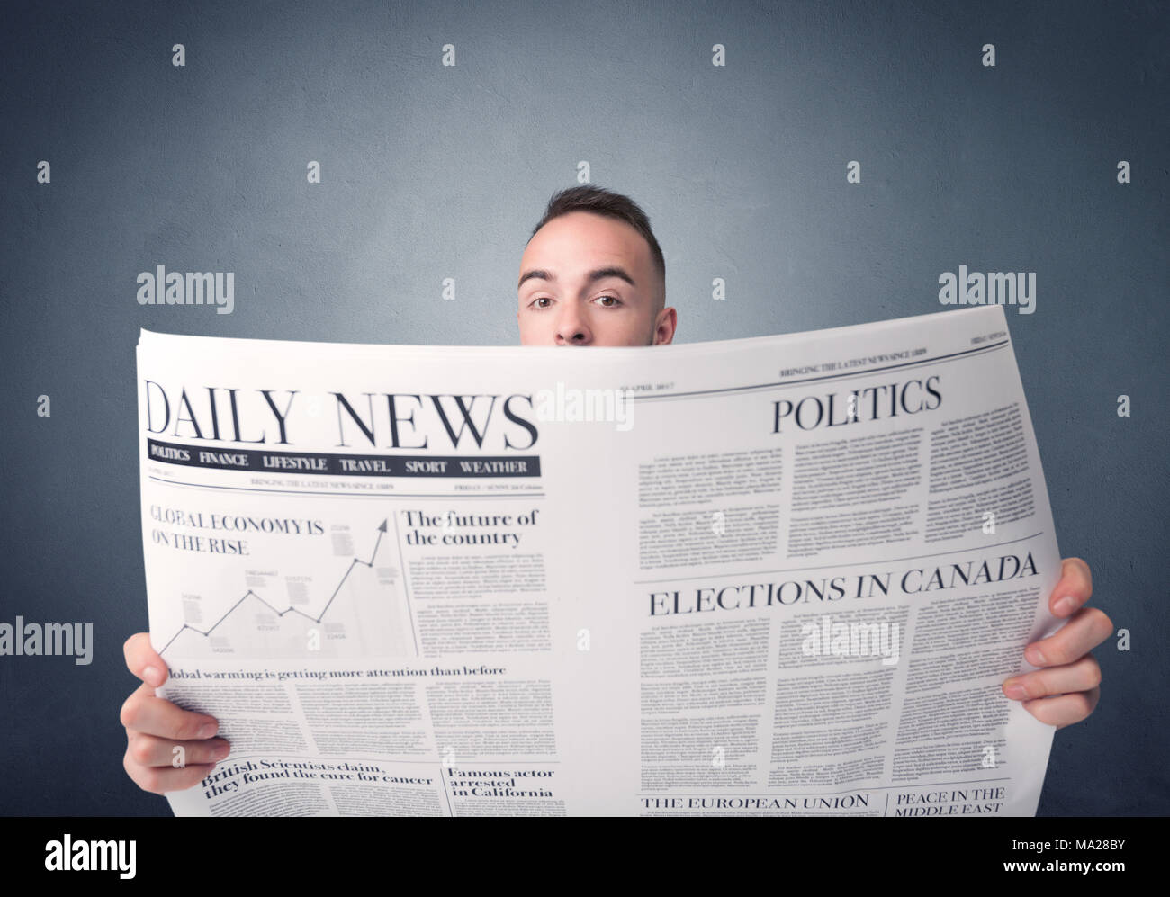 Young smart businessman reading daily newspaper Stock Photo - Alamy