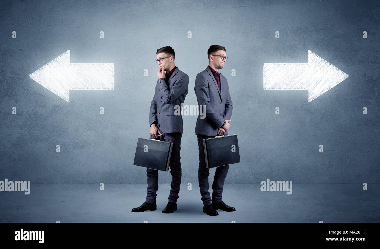 Young conflicted businessman choosing between two directions Stock ...