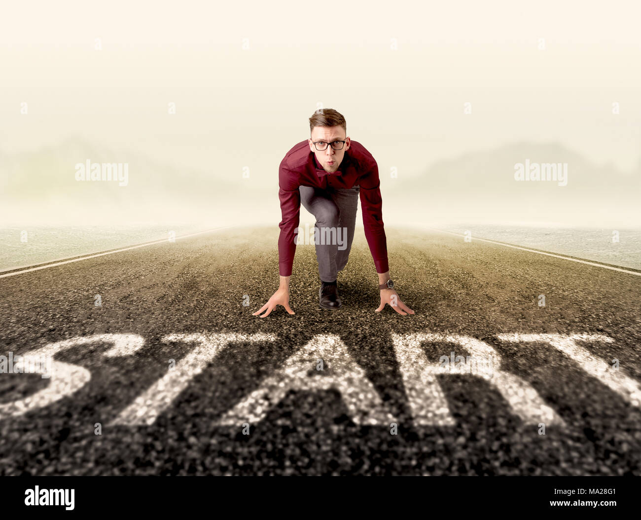 Young determined businessman kneeling at a start line Stock Photo - Alamy