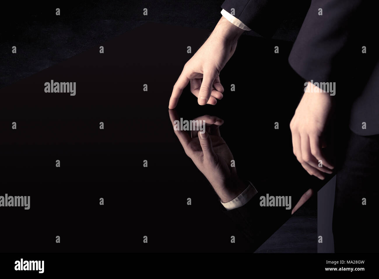 Close up of a hand touching smart table with copy space on black ...