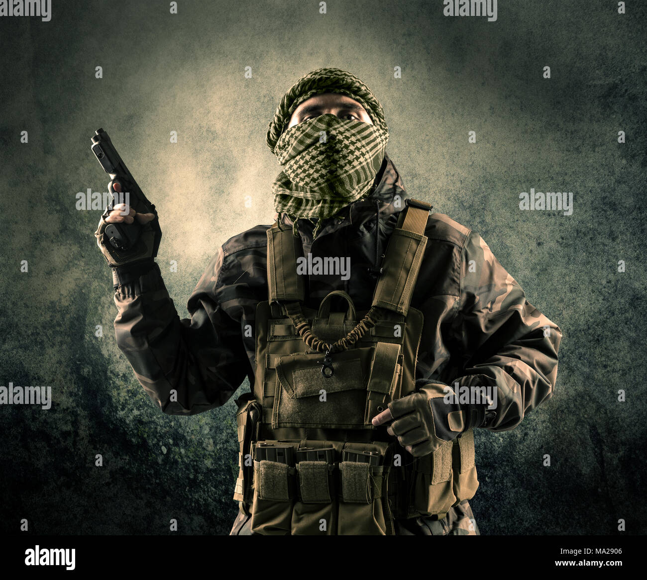 Portrait of a heavily armed masked soldier with grungy background ...