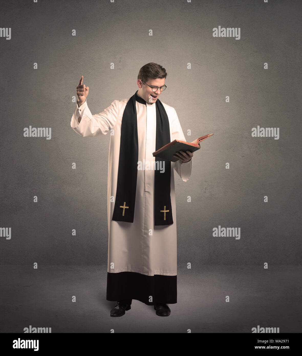 young priest in giving his blessing Stock Photo - Alamy