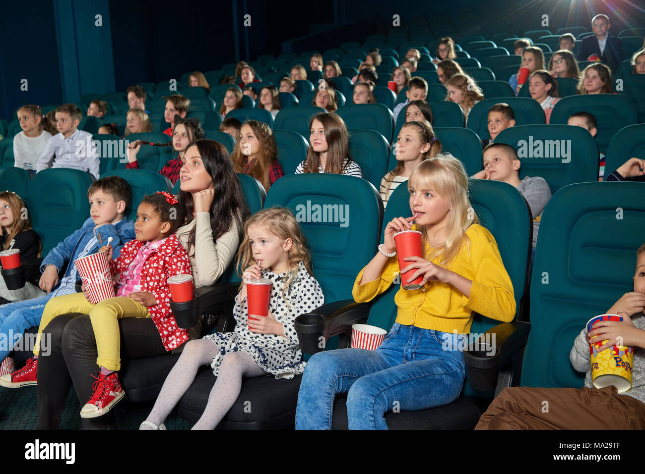 Emotional people watching film in the new cinema. There are adults and ...