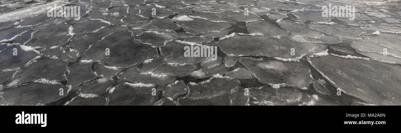 Ice floating in the ocean water at the harbour of Risor, winter in ...