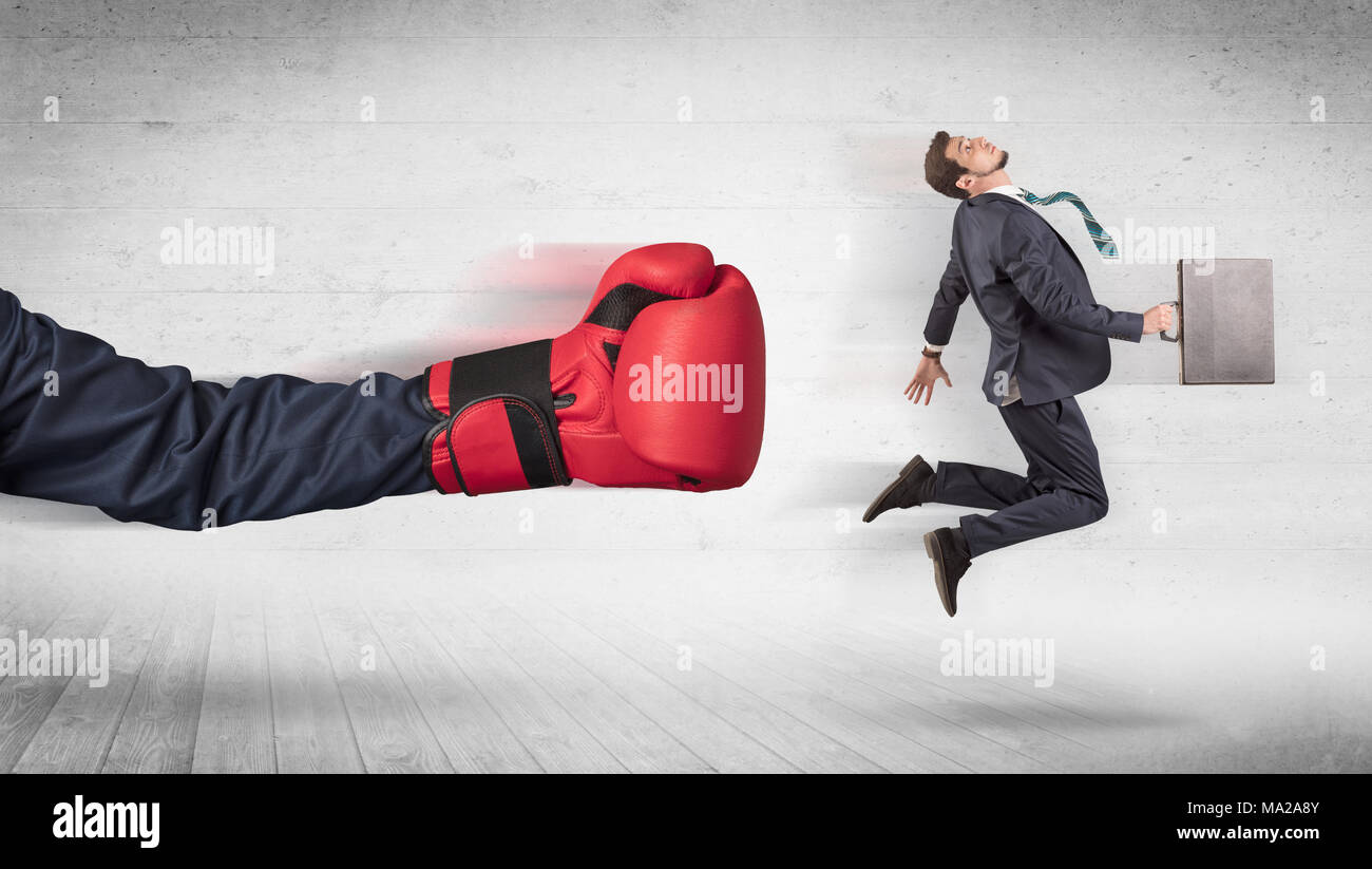 Arm with red boxing gloves hits office worker concept Stock Photo - Alamy