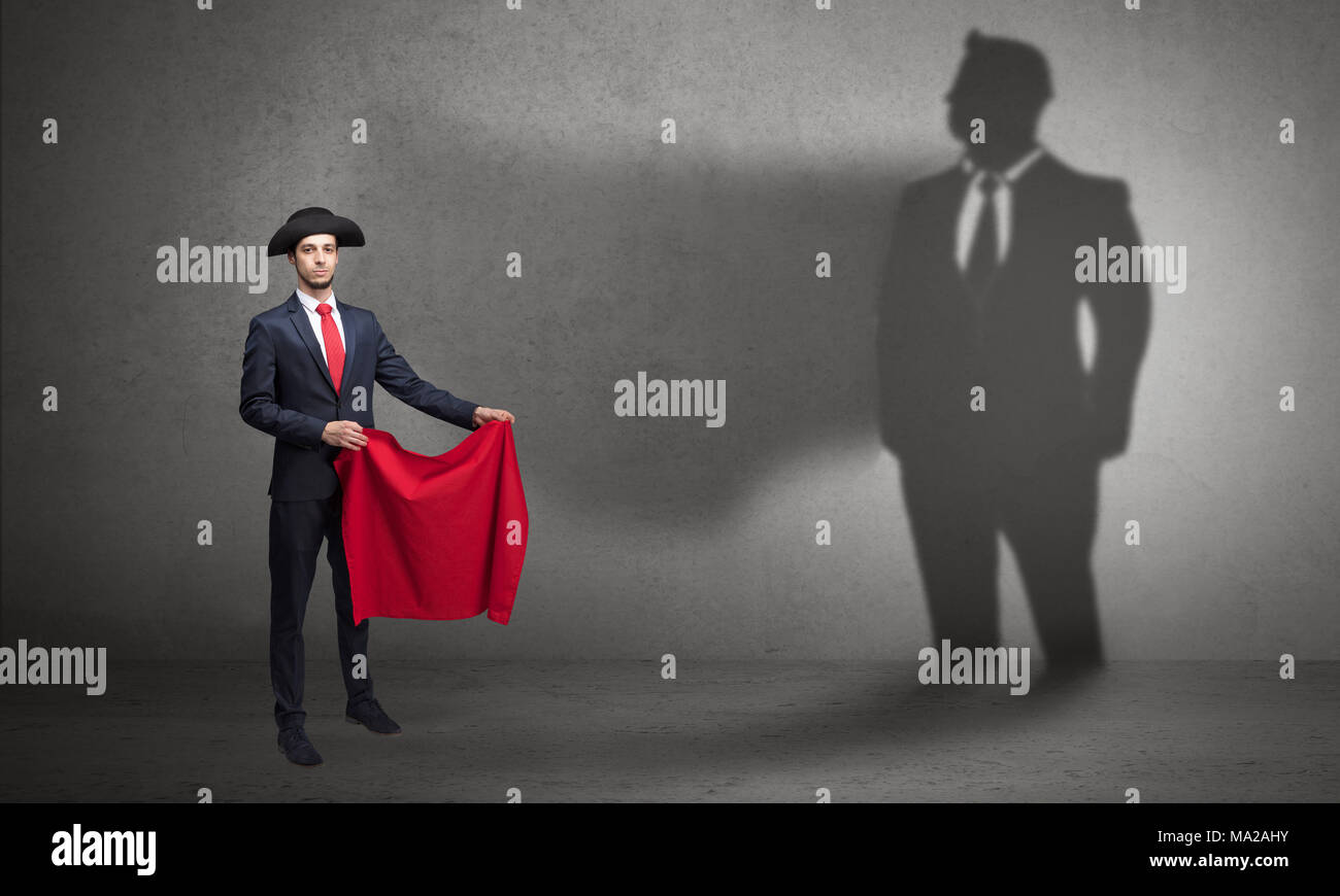 Businessman standing with red cloth on his hand and his shadow on the ...