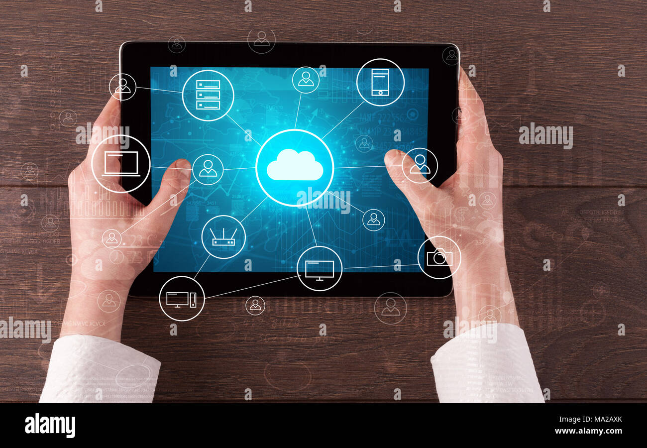 Hand touching tablet with cloud computing and online storage concept ...