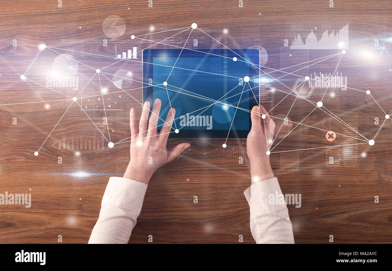 Hand using tablet with linking graphs charts report and informational ...