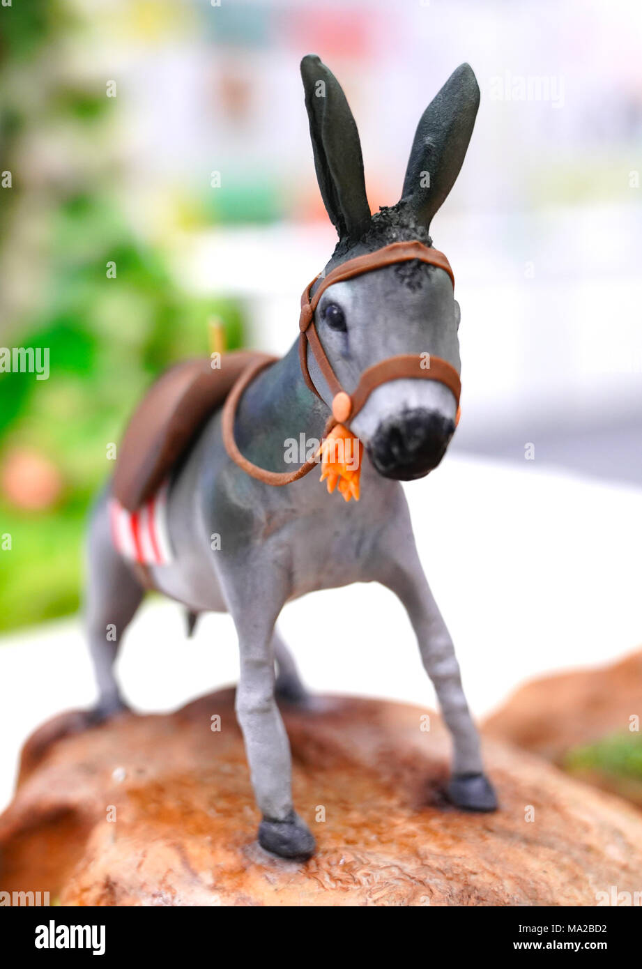Tiny decorative and colorful figurine of a donkey Stock Photo - Alamy