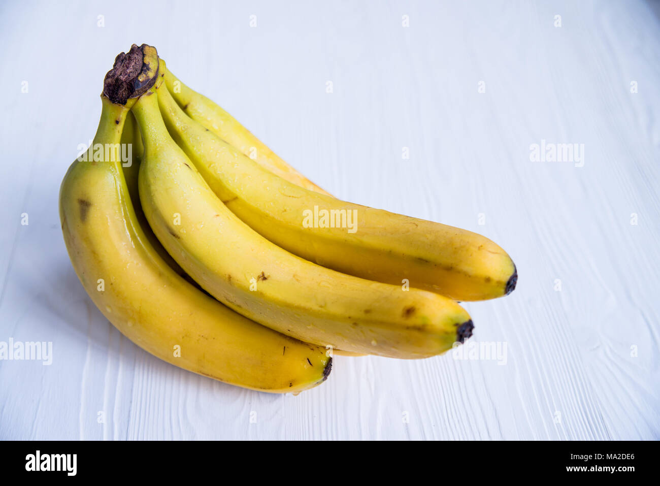 Yellow banana lying on table hi-res stock photography and images - Alamy