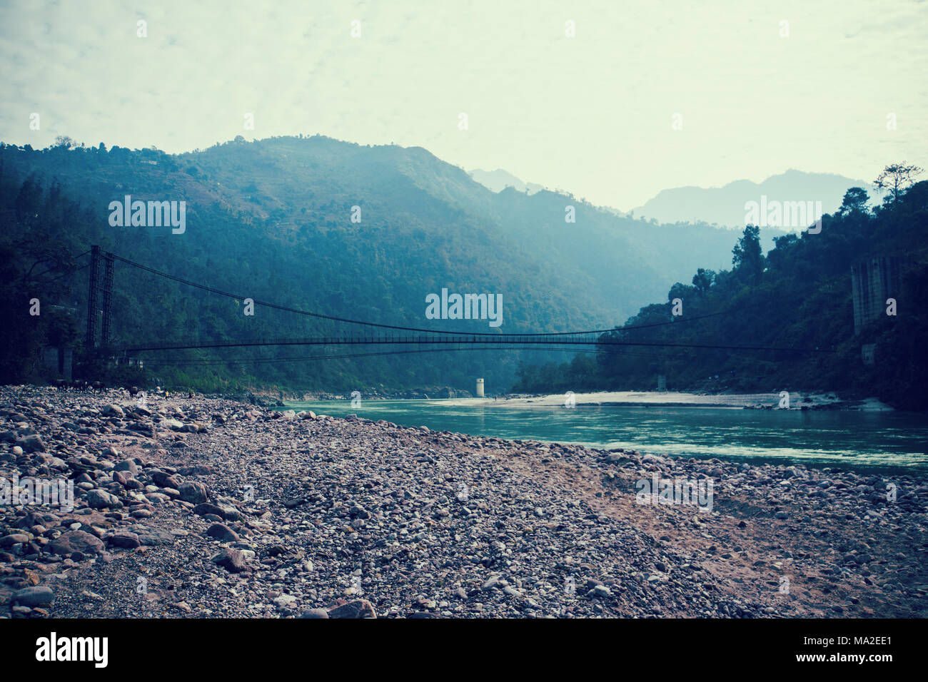 A beautiful landscape in the mountains with a bridge over the Ganges ...