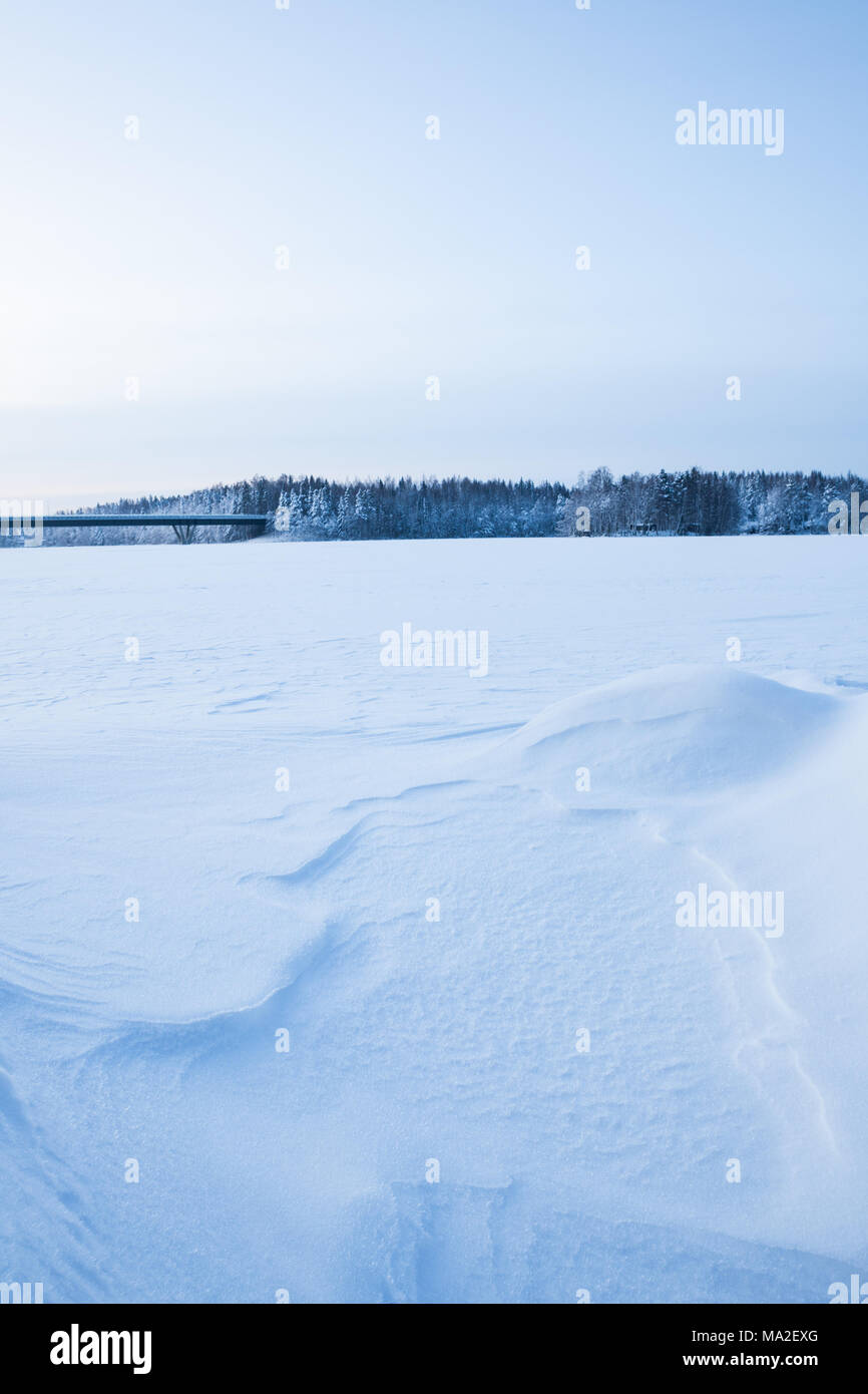 Wavy wind patterns in snow at lake Stock Photo - Alamy