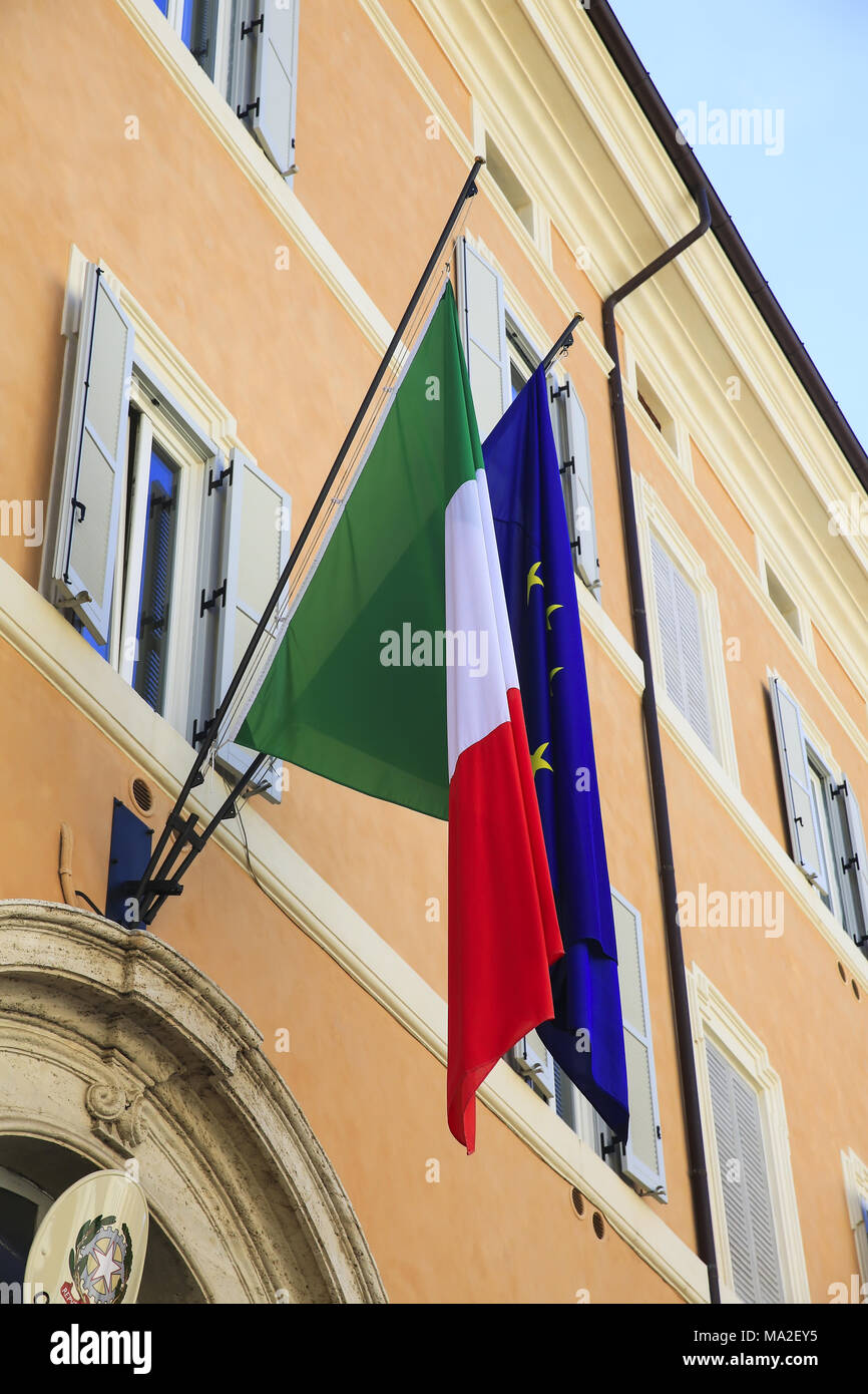 Italian and European flag on the facade of the building in Rome, Italy ...