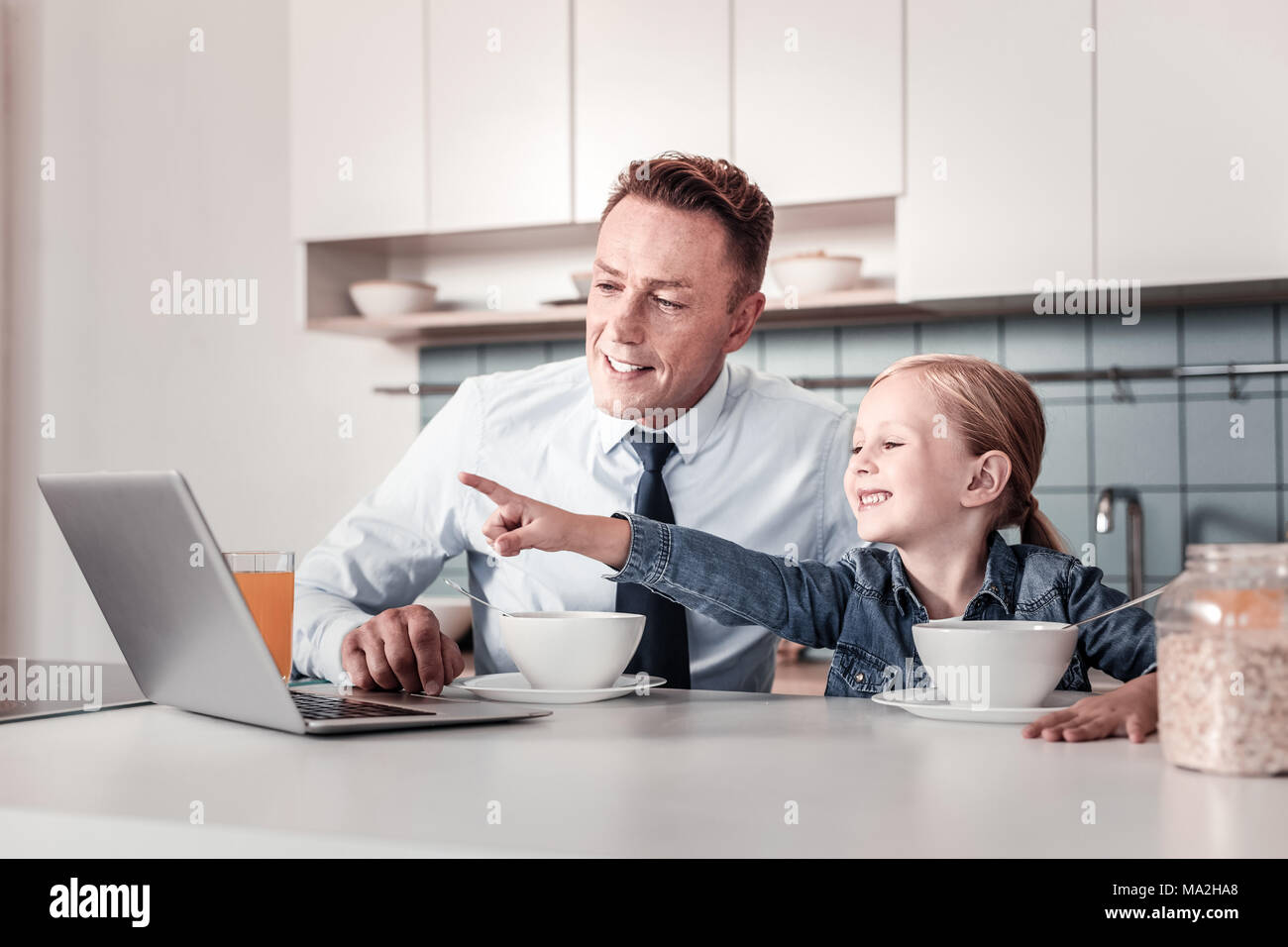 Look here. Positive male person keeping smile on his face and looking ...