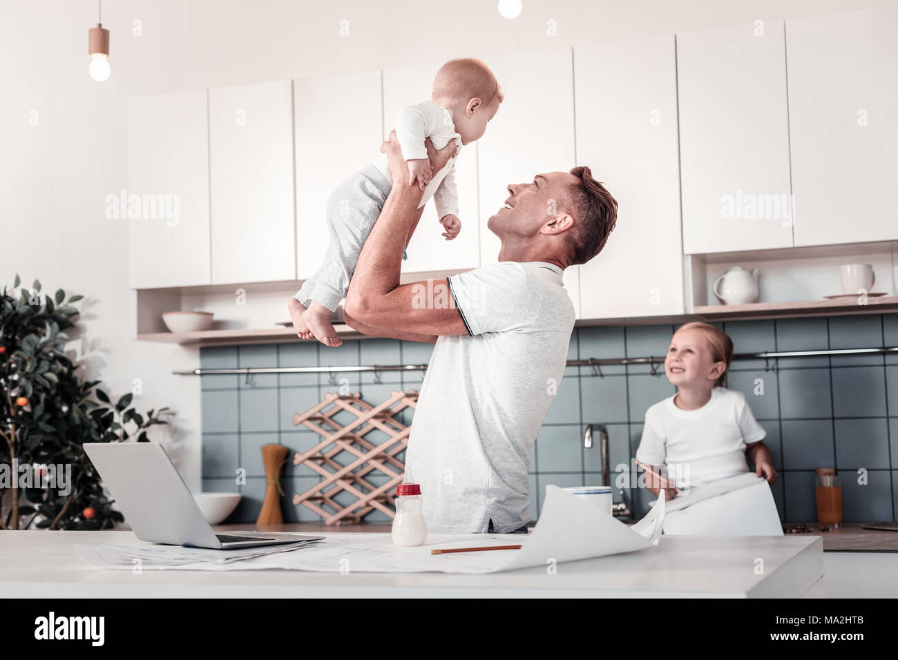 Handsome man playing with his children Stock Photo - Alamy
