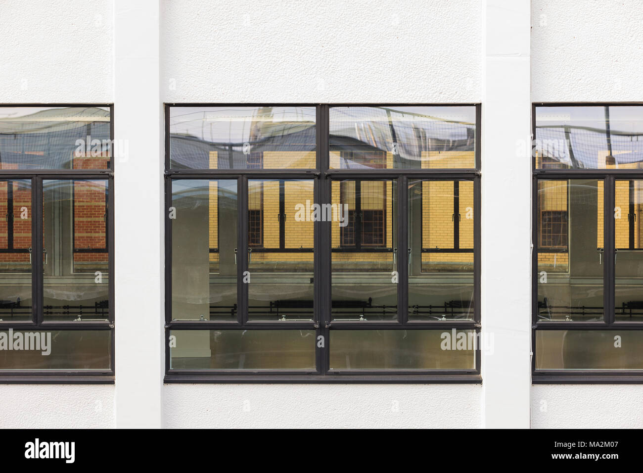 A view through the windows of an empty office block Stock Photo - Alamy