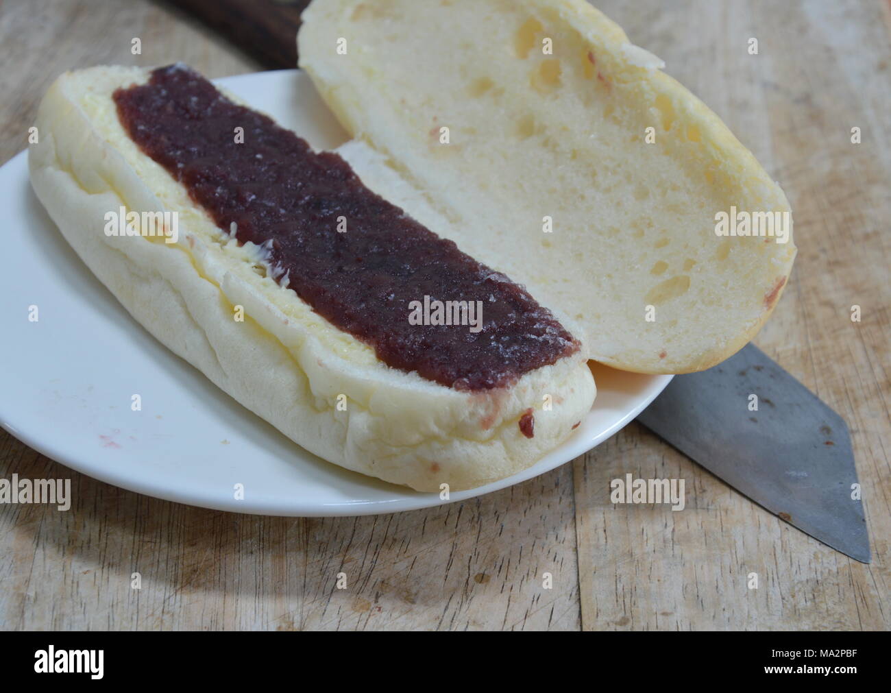 bread stuffed mashed red bean on wooden chop block Stock Photo - Alamy