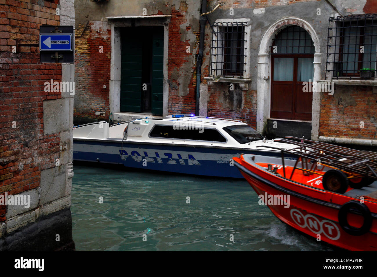 Police motorboat and delivery service motorboat at work Stock Photo - Alamy