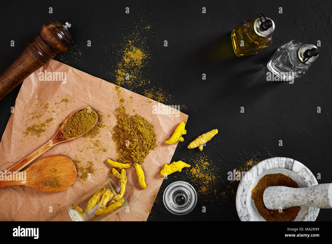 Turmeric Haldi powder in small bowl with raw whole in marble mortar ...