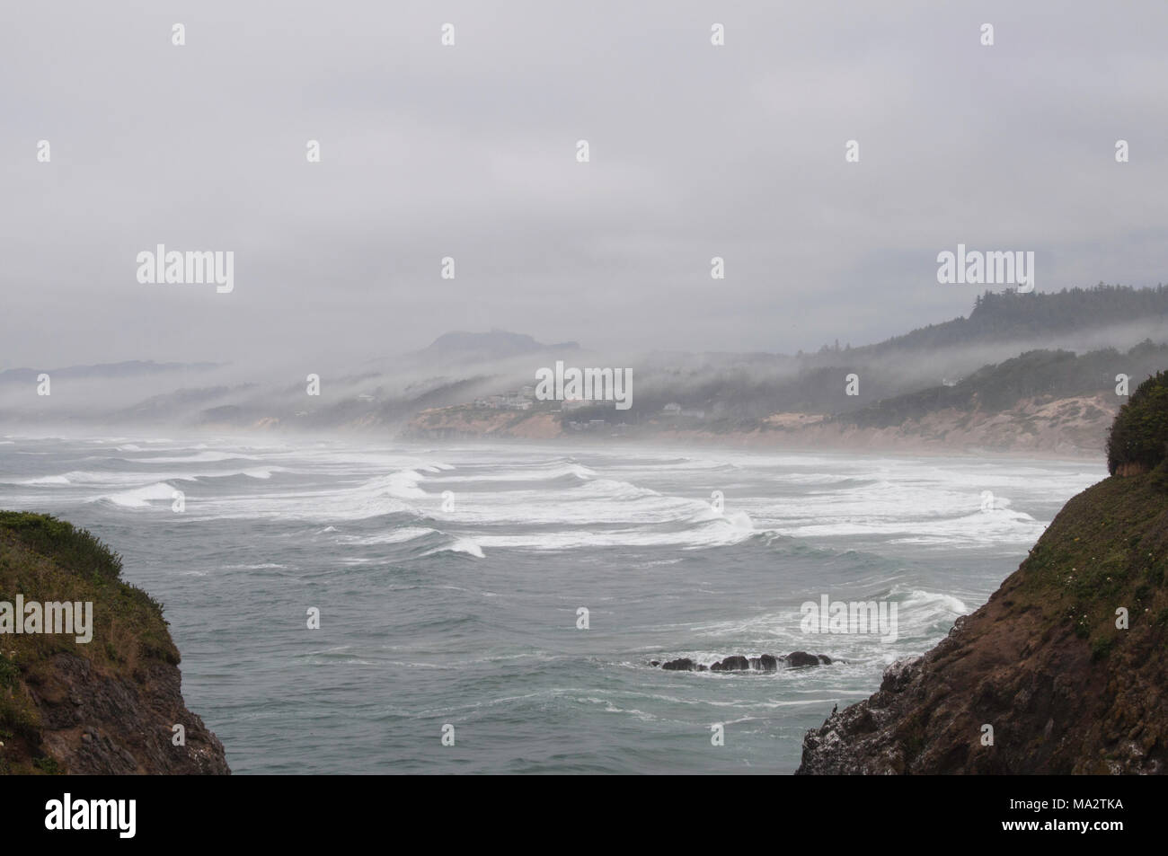 Oregon coast with clouds and fog rolling in Stock Photo - Alamy