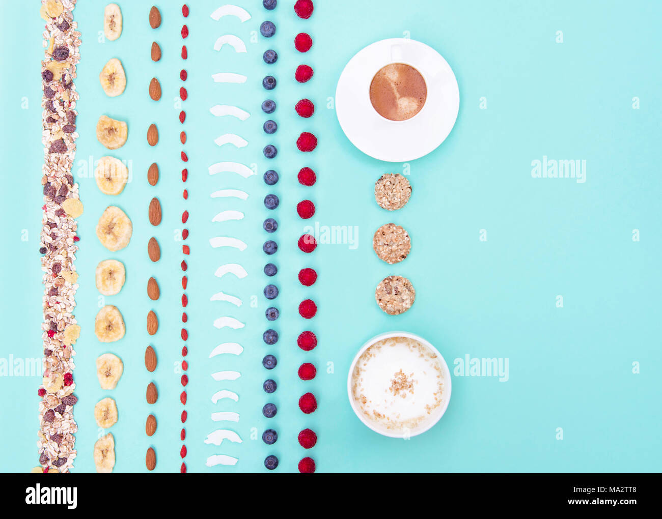 Breakfast with berries and nuts on mint background, copy space ...