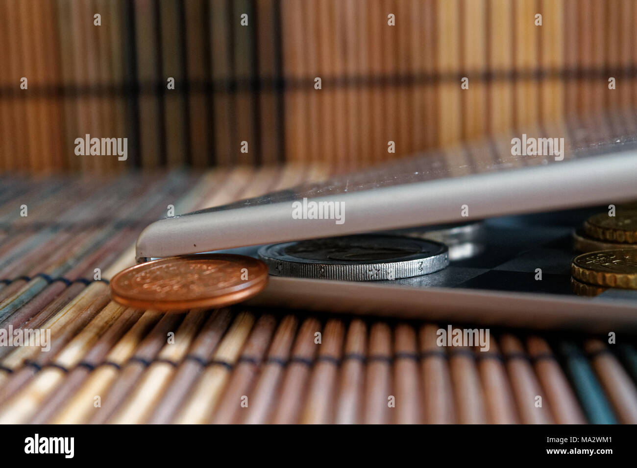 Pile of Euro coins in mirror reflect wallet lies on wooden bamboo table ...