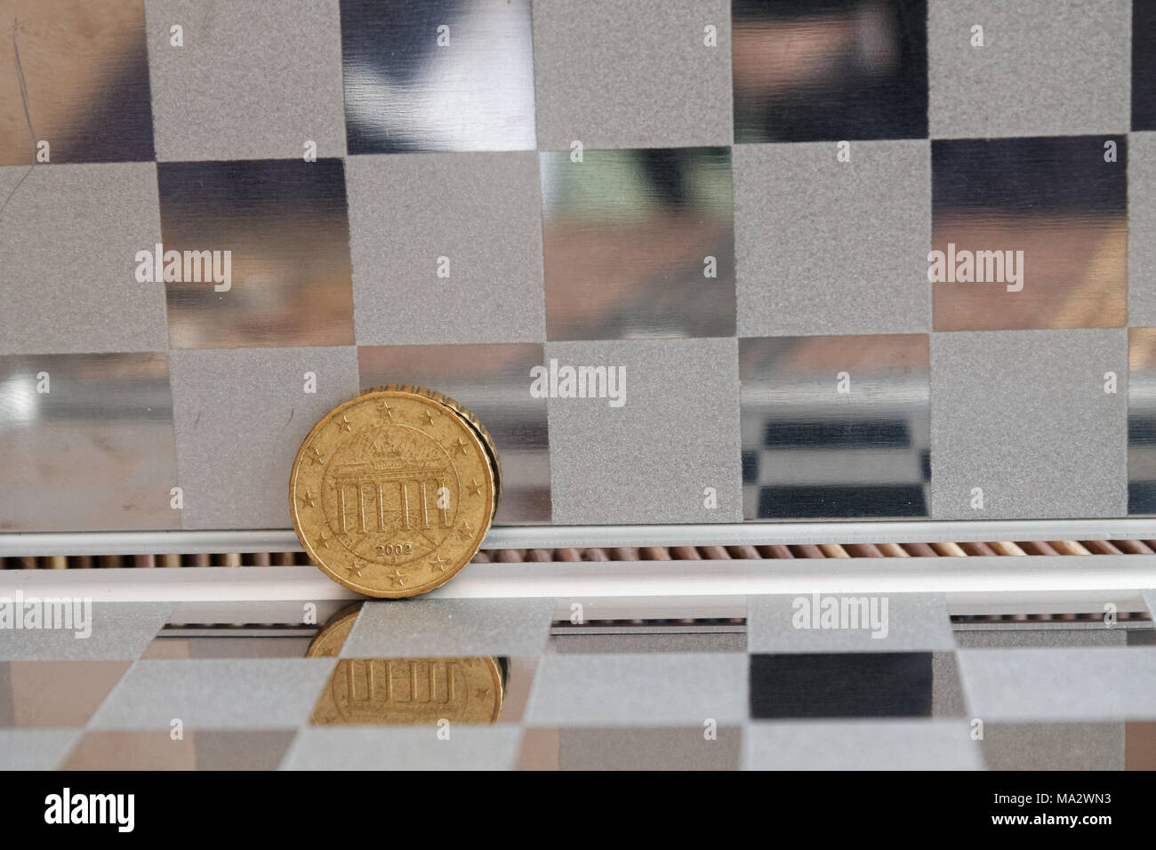 Euro coins in mirror reflect wallet lies on wooden bamboo table ...