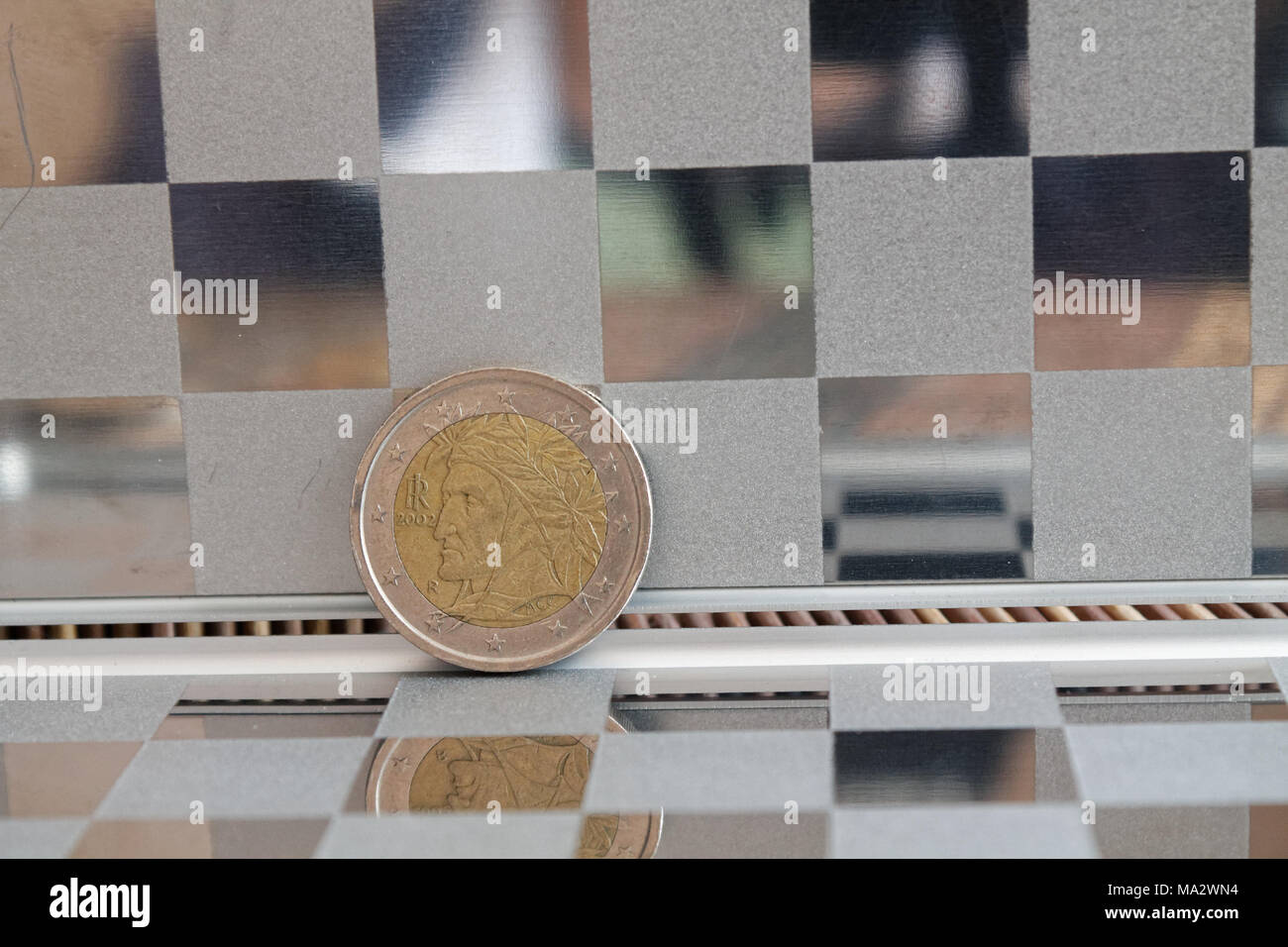 Euro coins in mirror reflect wallet lies on wooden bamboo table ...